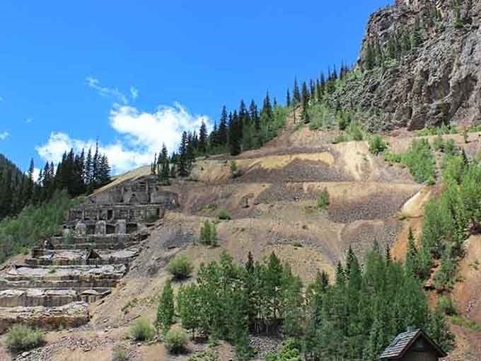 The old mill ruins stand as monuments to Colorado's mining glory days, weathered but still impressively standing tall.
