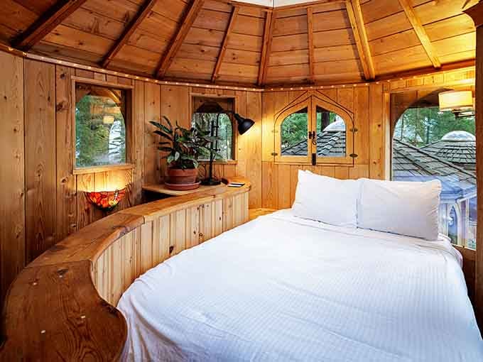 Crisp white linens against warm wood create a cocoon of comfort that'll have you hitting snooze repeatedly without guilt.