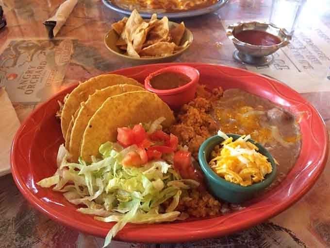 Chicken tacos on a plate so colorful and loaded, it's practically a fiesta waiting to happen.