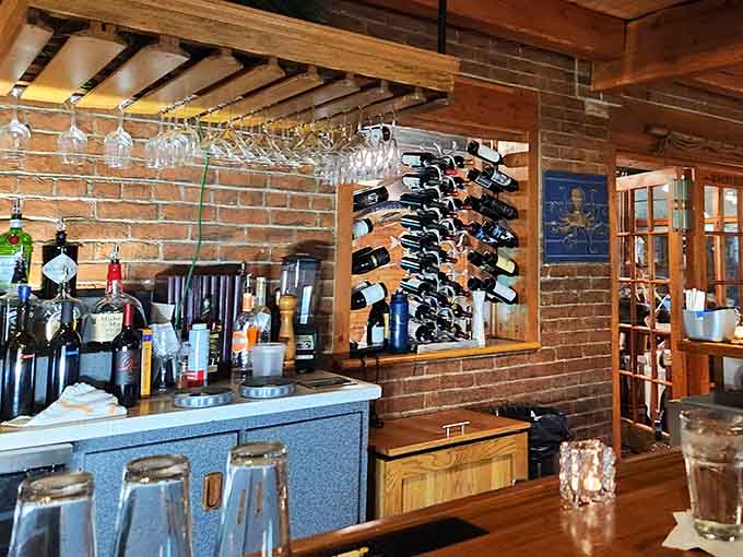 The bar area showcases wine bottles like trophies, ready to complement whatever the ocean has offered today.
