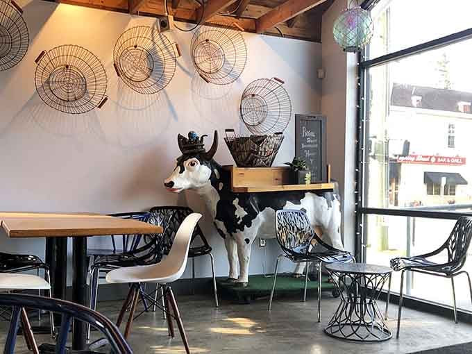 Quirky decor featuring wire baskets and a cow statue, because normal is overrated anyway.