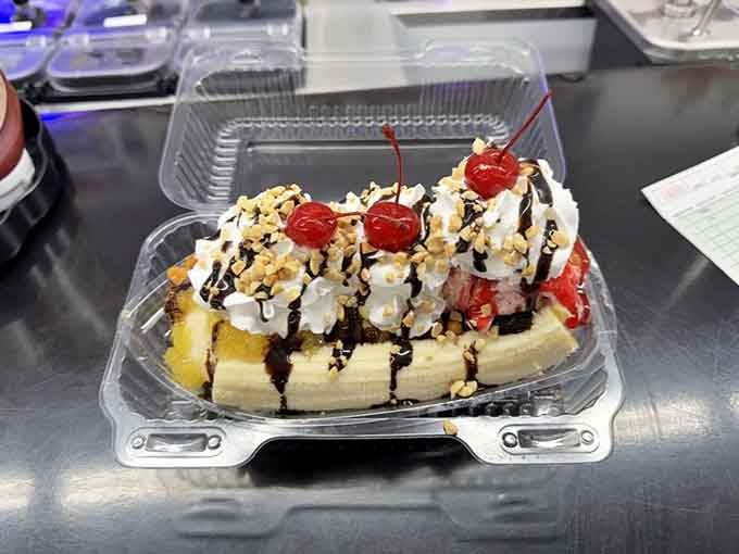 The banana split reigns supreme in its glass throne, drizzled with chocolate and topped with whipped cream glory.