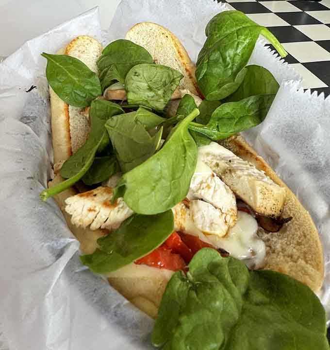 Fresh spinach crowns this grilled chicken creation like a healthy halo over something wonderfully indulgent and satisfying underneath.