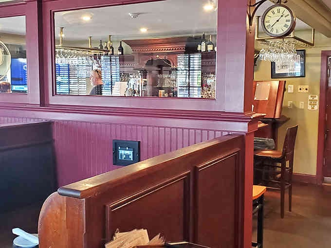 Classic pub booths and warm wood tones create that cozy English atmosphere you've been craving all along.