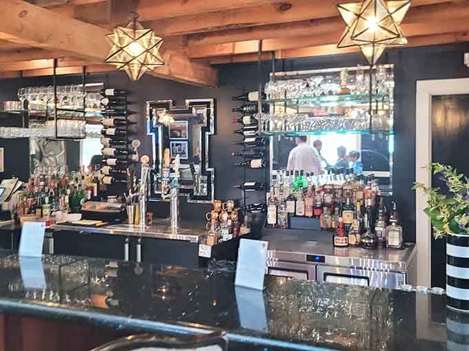 Star-shaped pendant lights illuminate a well-stocked bar where craft cocktails meet exposed beam rustic charm beautifully.