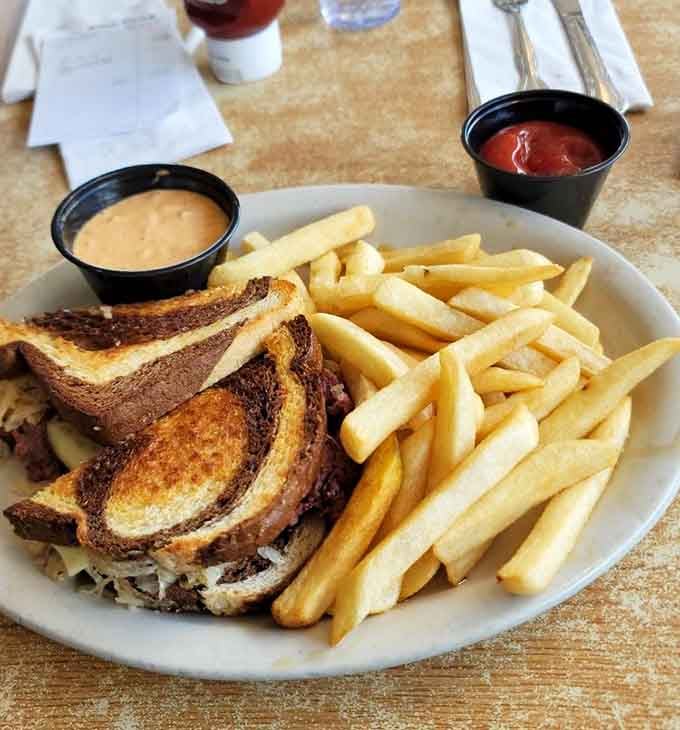 A Reuben on marble rye with fries: the sandwich that never needs an introduction.