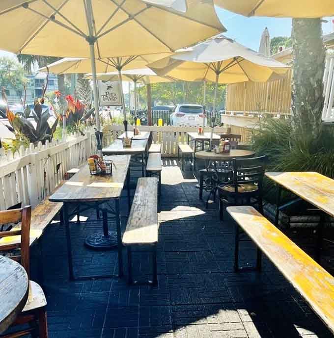 Picnic tables under yellow umbrellas create the perfect spot for contemplating life's mysteries and ordering seconds.