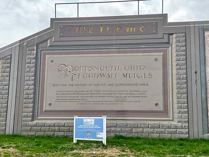 The welcome sign that greets every visitor—because even floodwalls deserve a proper introduction to their story.