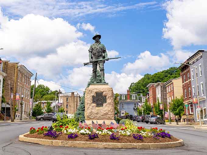 Garfield Square's soldier stands watch over flowers and history, anchoring downtown with quiet dignity and community pride.
