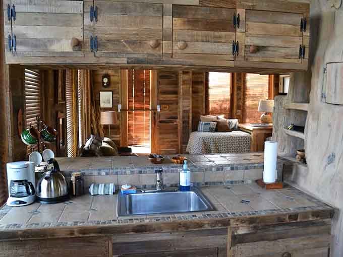 The kitchen sink overlooks the sleeping area, because open concept living reaches new heights in a treehouse.