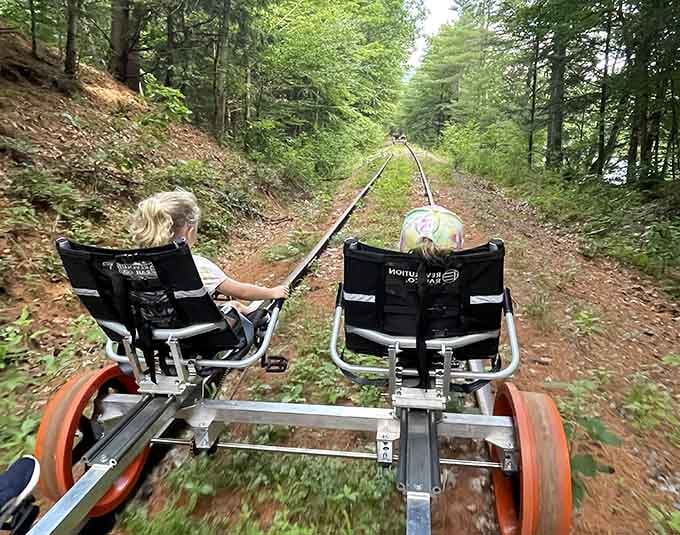 The forest canopy creates a natural cathedral as riders venture deeper into terrain where nature still calls the shots.