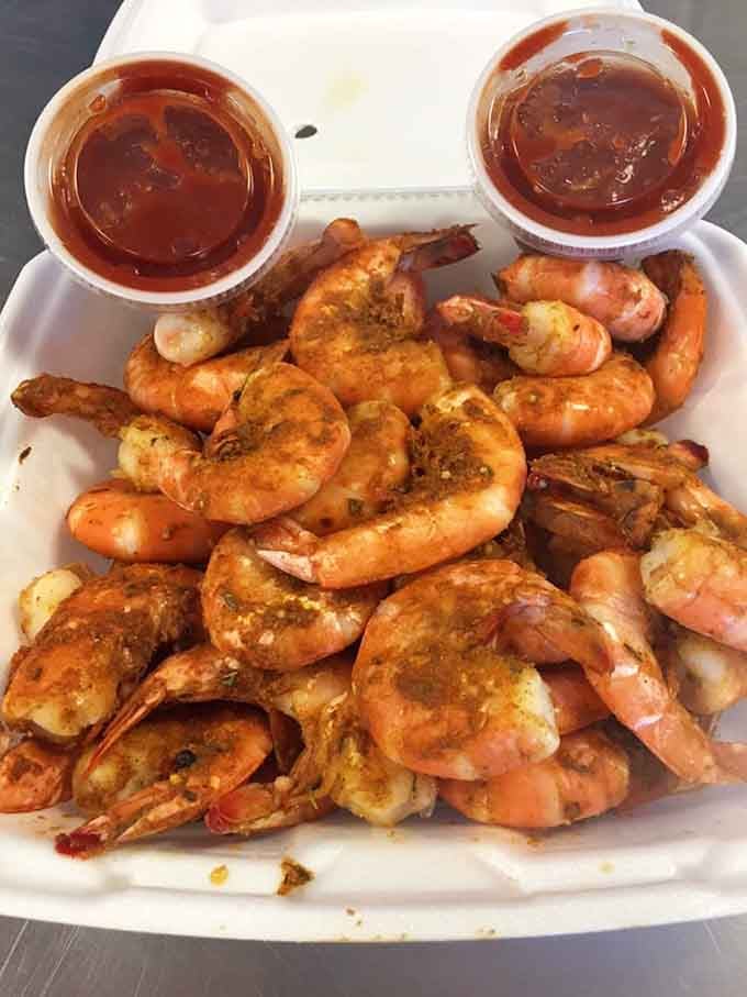 Steamed shrimp piled high with dual cocktail sauce cups, because one container is never enough for this kind of bounty.