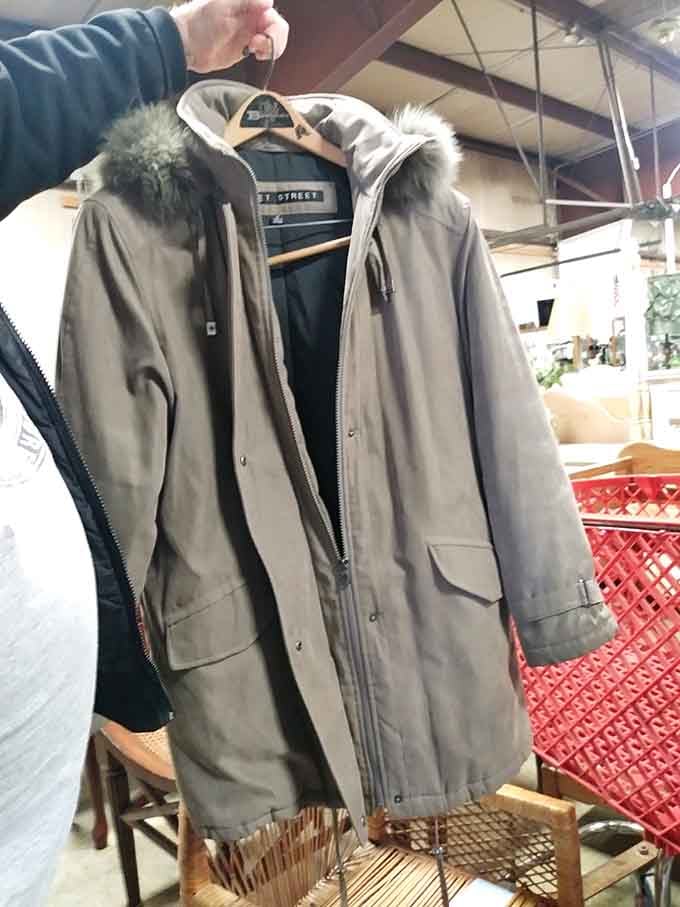 That fur-trimmed parka hanging ready proves winter warmth doesn't require taking out a second mortgage on your house.