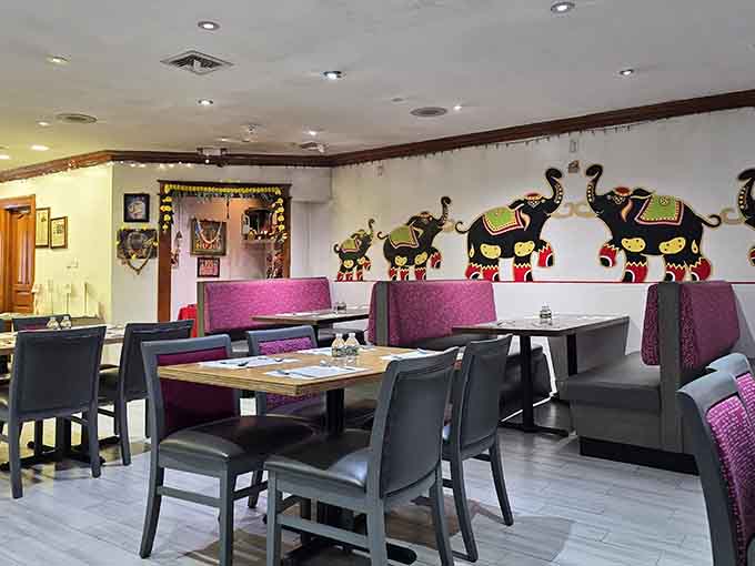 Booth seating with decorative elephant art adds charm without overwhelming the space, creating a welcoming dining atmosphere throughout.