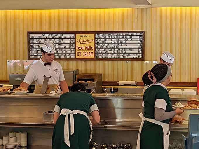 Behind that counter, skilled hands are crafting burgers with the precision of seasoned artists at work.