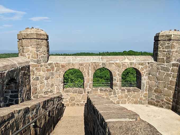 Three perfect windows showcase Connecticut's rolling hills, each arch offering its own masterpiece of green and blue beyond.