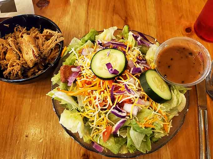 Fresh salad with pulled pork because sometimes you need vegetables to justify ordering more barbecue later.