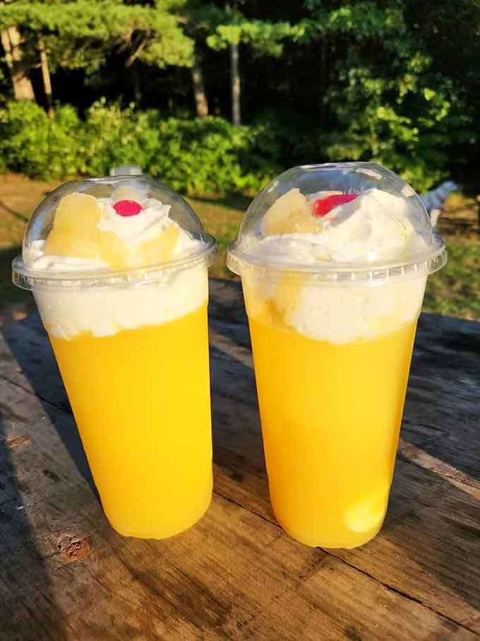 Bright mango coolers topped with whipped cream and cherries, making summer taste exactly like it should taste.