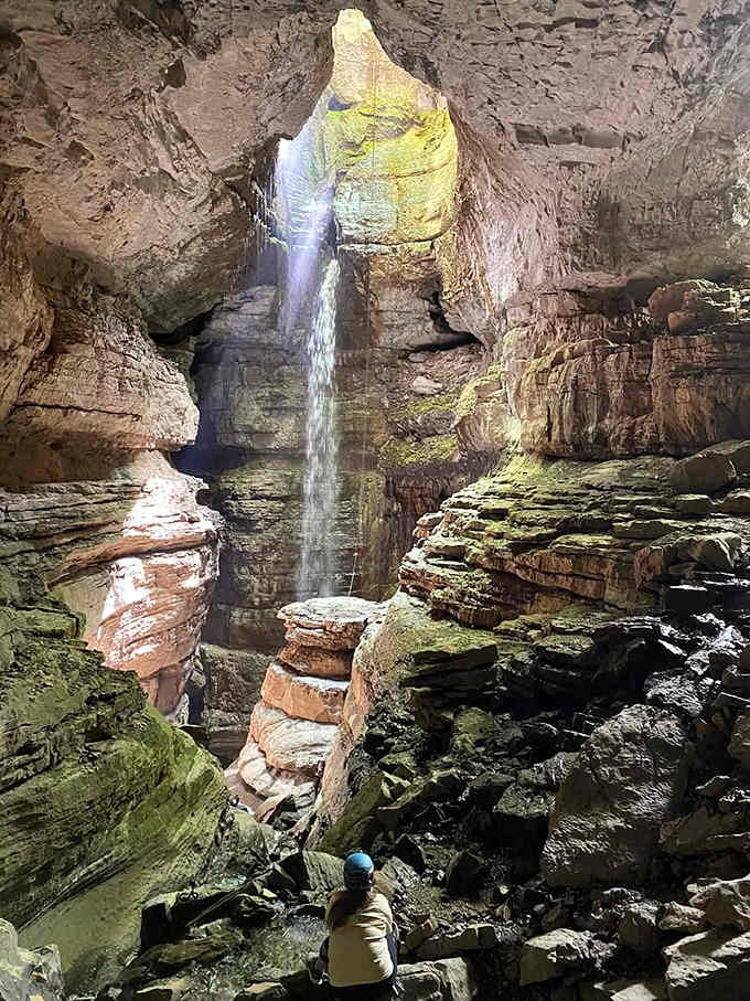 Looking up from the cave floor at that perfect circle of sky feels like peering through a portal to another dimension.