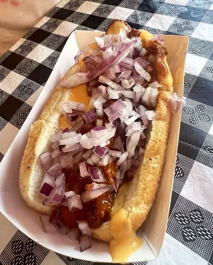 When chili and onions meet a hot dog, beautiful things happen that make your taste buds sing.