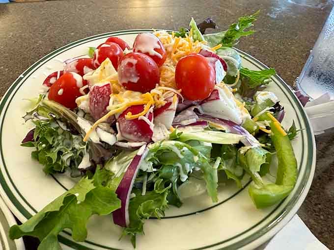 Fresh salad loaded with garden vegetables reminds you that eating responsibly before dessert is totally a legitimate dining strategy.