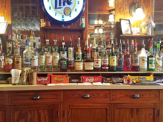 Tito's, Maker's Mark, Jack Daniel's, and a front row of candy bars. This bar has its priorities completely figured out.