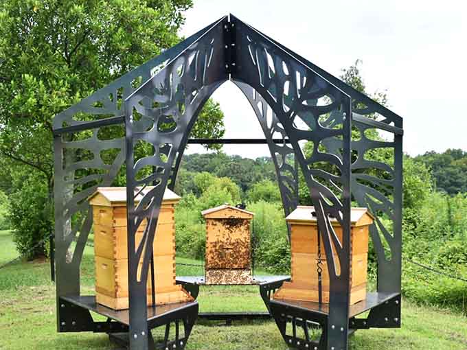 Beehives housed in artistic structures, where pollinators work harder than most of us ever will daily.