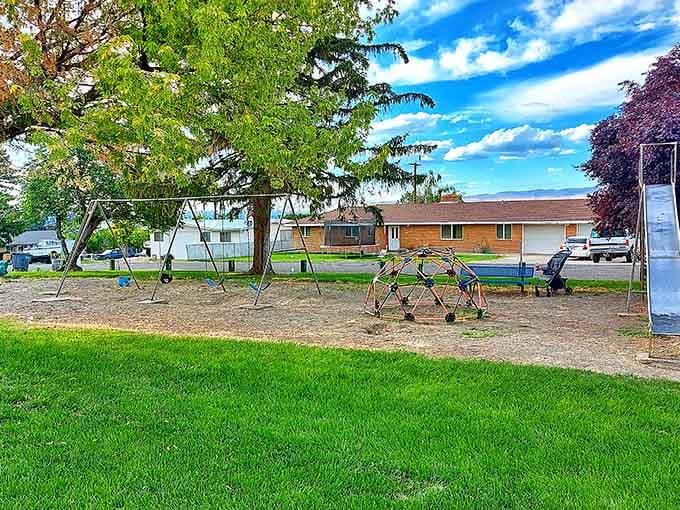 Upland Park's playground equipment sits ready under endless blue skies, waiting for kids who still play outside instead of on screens.