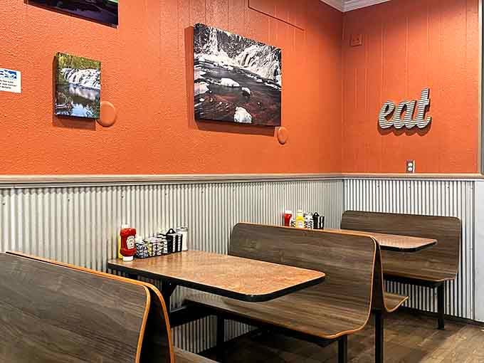Corrugated metal wainscoting and warm orange walls create that perfect small-town diner atmosphere we all crave.