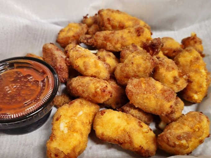 Cheese curds fried to golden glory, proving Wisconsin doesn't have a monopoly on dairy-based deliciousness after all.