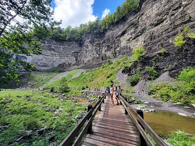 The wooden boardwalk leads you deeper into the gorge, building anticipation with every step forward.