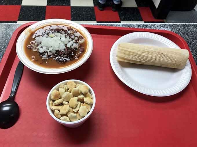 A tamale paired with chili and crackers shows how this place respects both tradition and creative combinations.