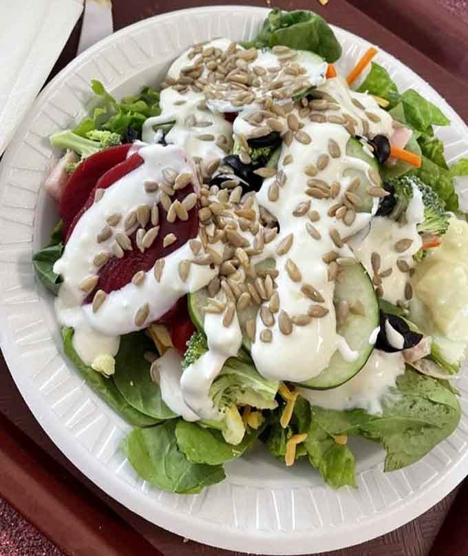 That salad's dressed up fancier than most people at a wedding, complete with sunflower seeds wearing their Sunday best.