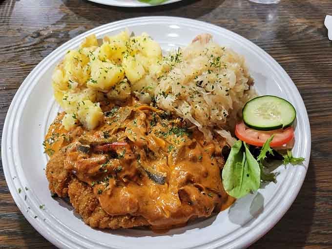 Crispy Wienerschnitzel with parsley potatoes and sauerkraut delivers everything you want from authentic German cooking in one beautiful plate.