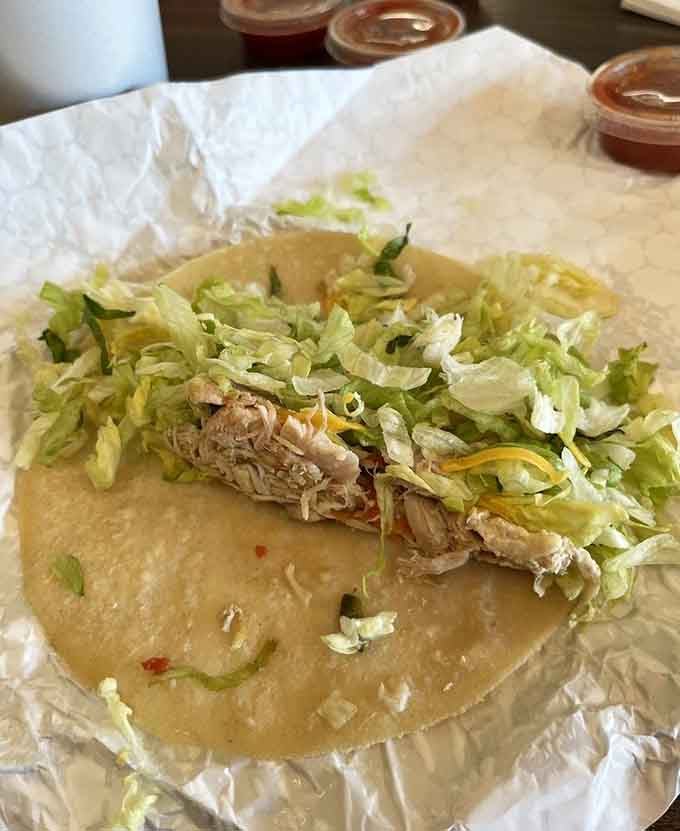 Shredded chicken piled high on a handmade tortilla with crisp lettuce proves simplicity beats complexity every single time.
