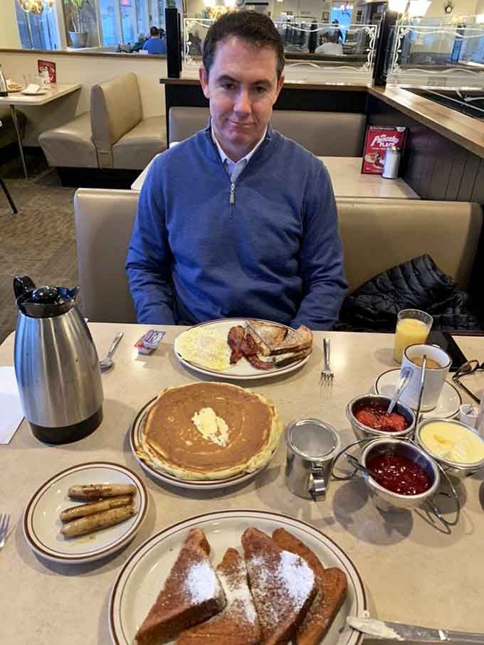 One happy customer proves that giant pancakes and good company make the perfect Sunday morning equation.