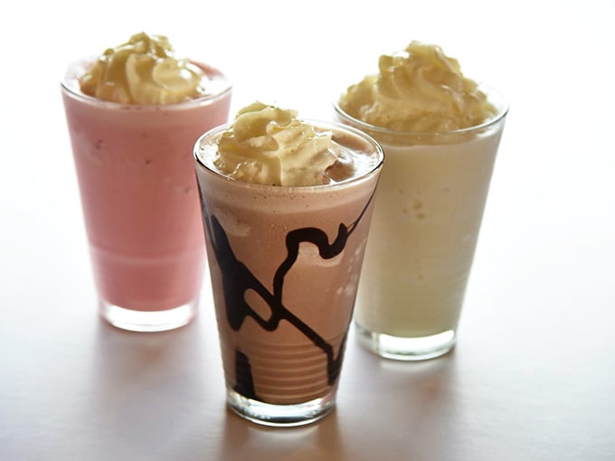 Three milkshakes standing tall, each flavor a different adventure in creamy, dreamy indulgence waiting.