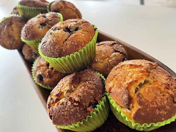 Fresh-baked muffins in their cheerful green wrappers promise homemade goodness that actually delivers on that promise every single time.