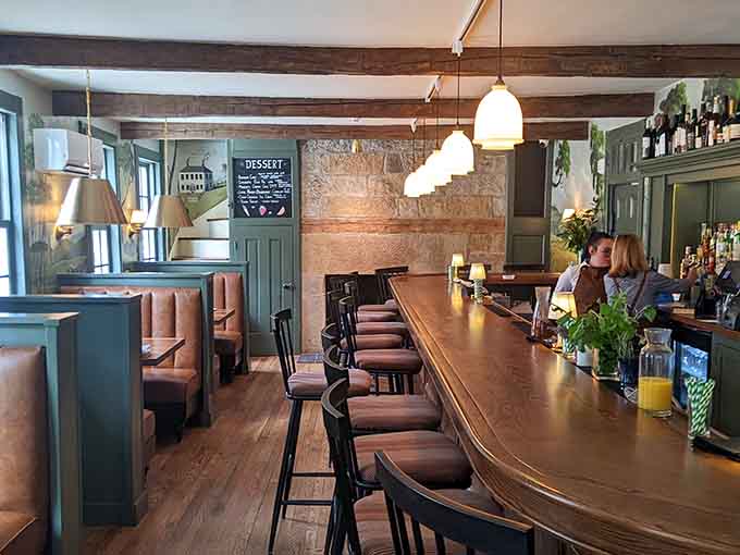 The bar area where craft cocktails flow and the exposed brick whispers stories from decades of good times past.