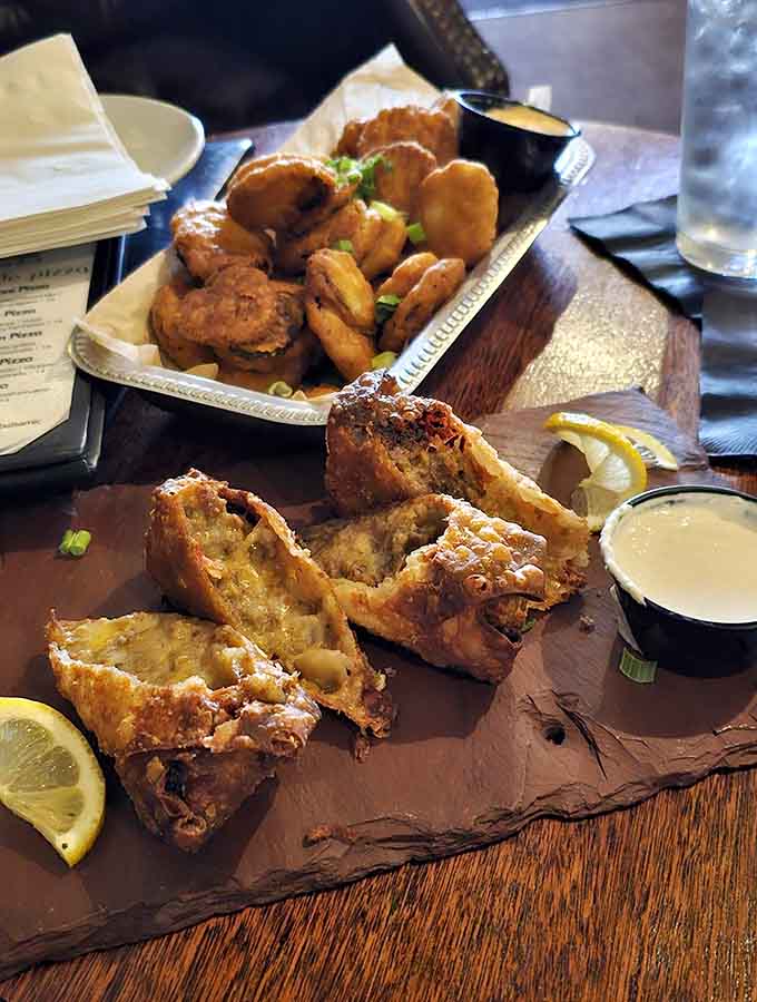 Golden fried perfection piled high with dipping sauce standing by like a trusty sidekick in this delicious adventure.
