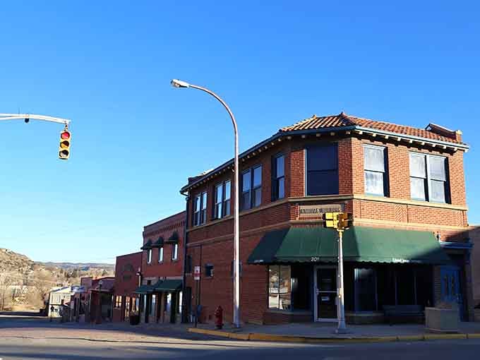 Brick storefronts and green awnings create a streetscape that hasn't needed updating since Eisenhower was president.