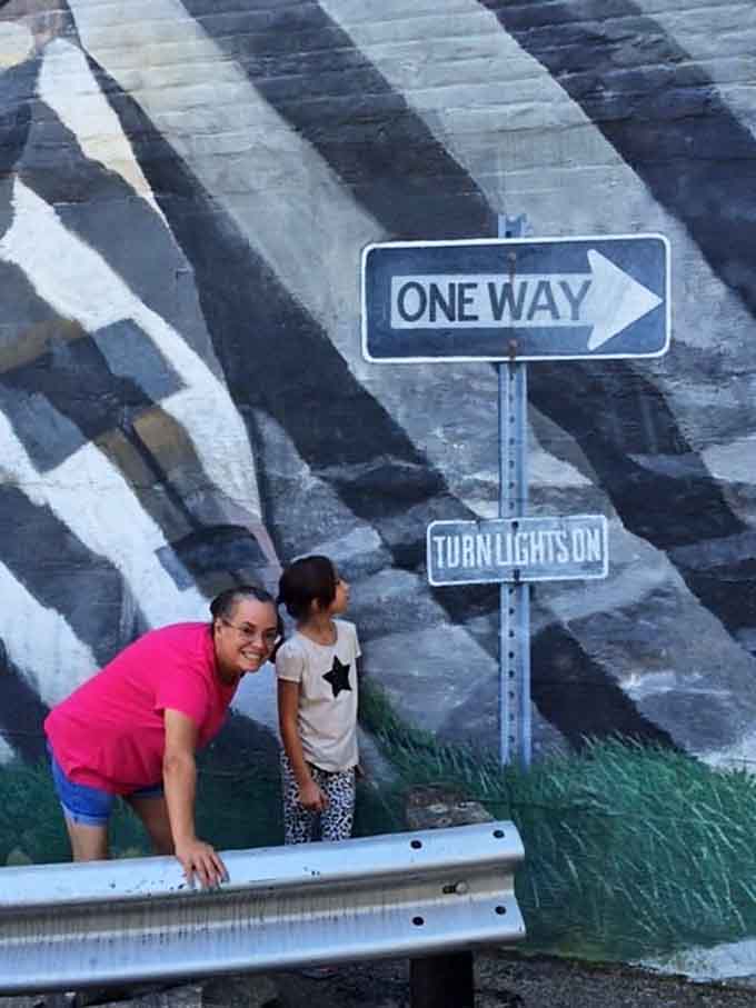 The painted road signs add another layer of whimsy to an already wonderfully confusing visual experience.