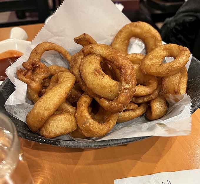 A basket of onion rings so perfectly golden and crispy, they deserve their own fan club and appreciation society.