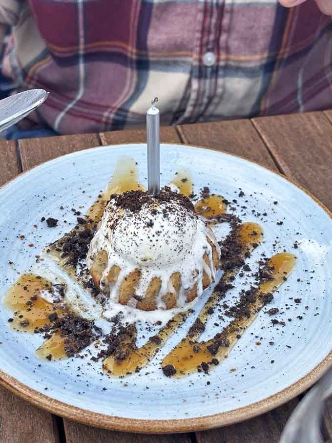 Dessert arrives with a candle like it's celebrating you, which is exactly the kind of attention we all deserve.