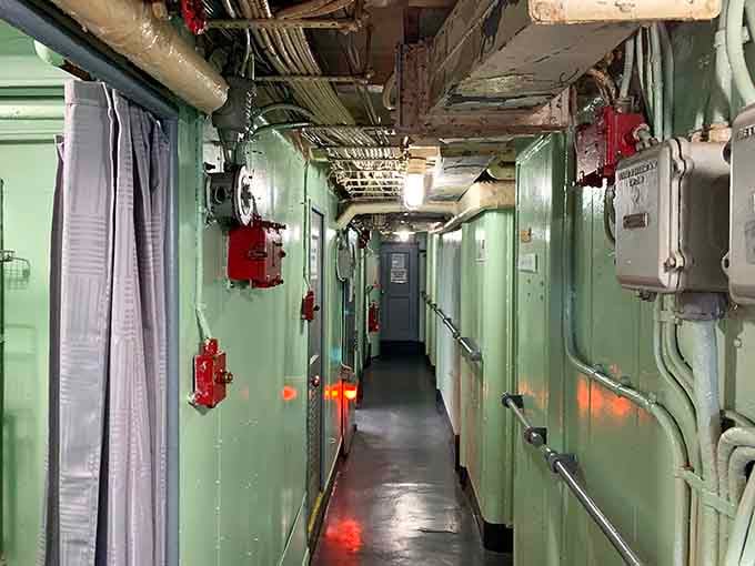 Narrow passageways painted mint green prove that even warships had someone's aunt picking out the interior colors.
