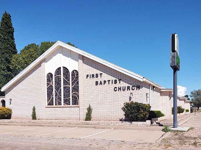 Classic white church architecture anchors this community, a beacon of faith standing strong against the West Texas elements.
