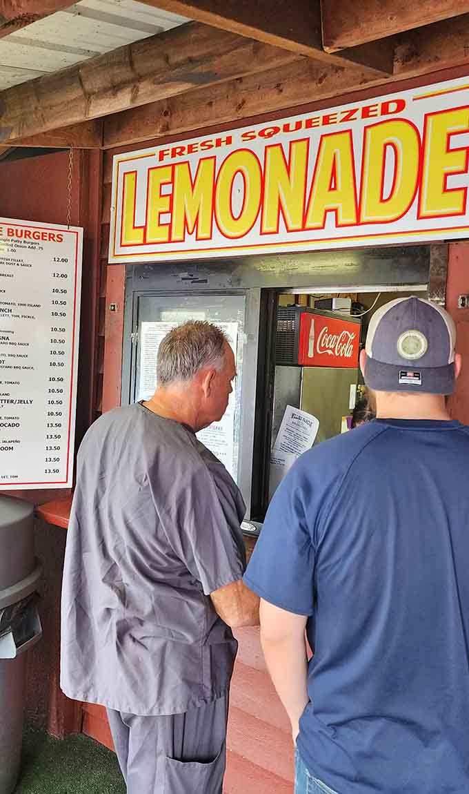 The order window where burger dreams become delicious reality, one perfectly assembled sandwich at a time for hungry customers.