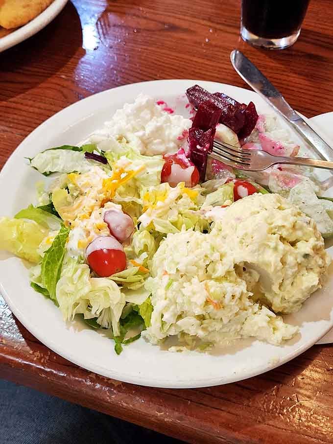 The salad bar offerings include potato salad, coleslaw, and beets for those seeking balance before tackling the main event ahead.
