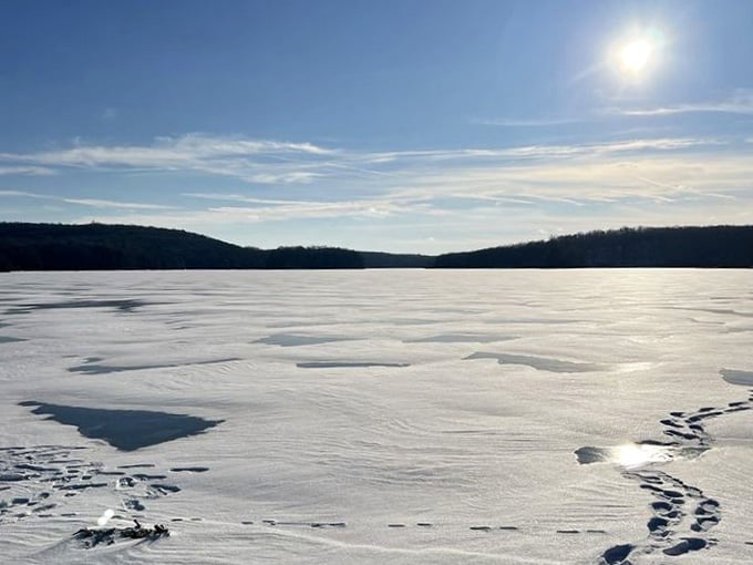 The frozen lake in winter transforms into a pristine white canvas, perfect for contemplating life or just avoiding holiday shopping.