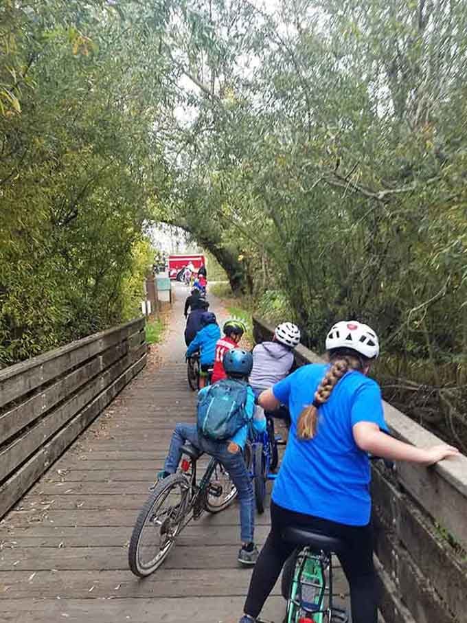 Families pedaling together through leafy tunnels, proving the best adventures don't require fancy equipment or reservations.